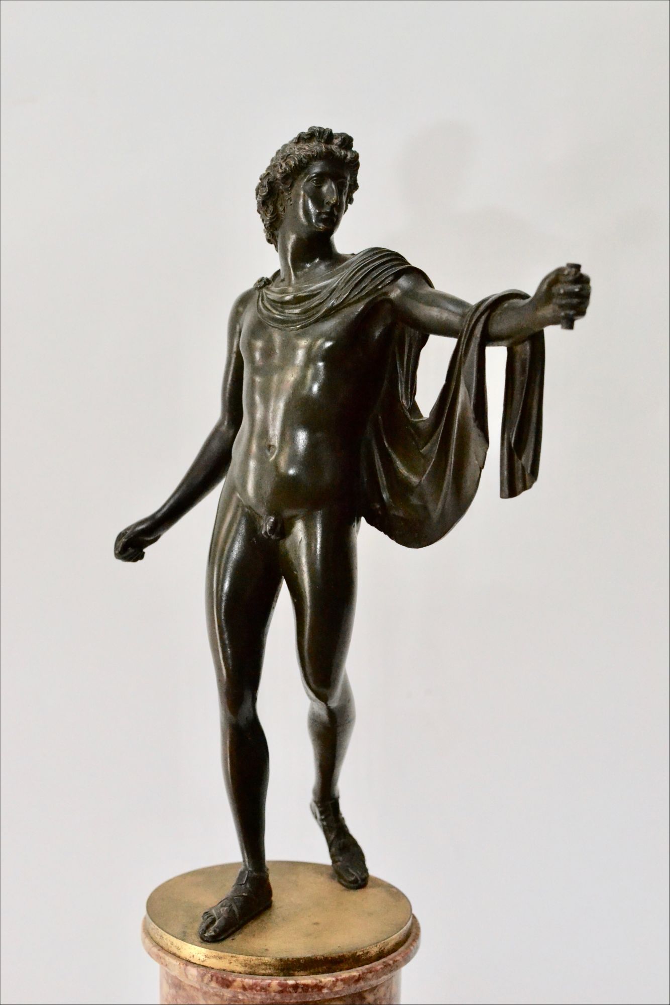 A Patinated Bronze Sculpture Of Apollo With An Ormolu Mounted Marble Base.