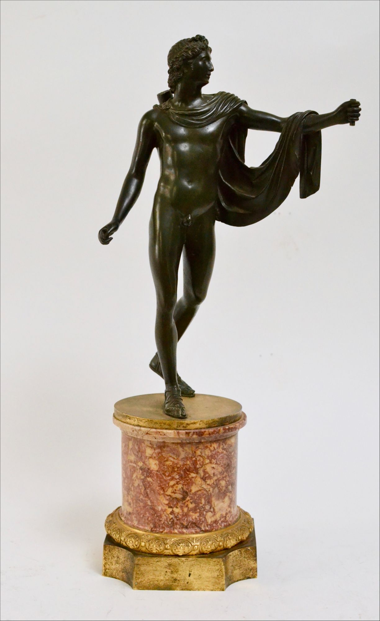 A Patinated Bronze Sculpture Of Apollo With An Ormolu Mounted Marble Base.